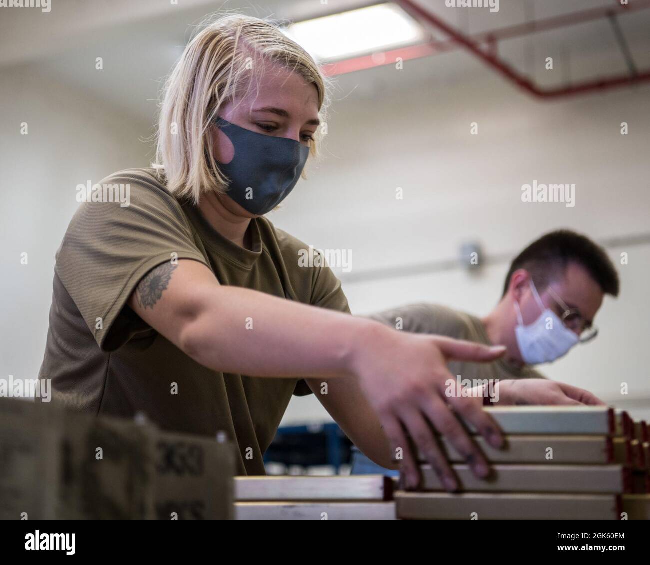 U.S. Air Force Airman 1st Class Skylar Schneider, left, and Staff Sgt. Marc Pelletier, right ...