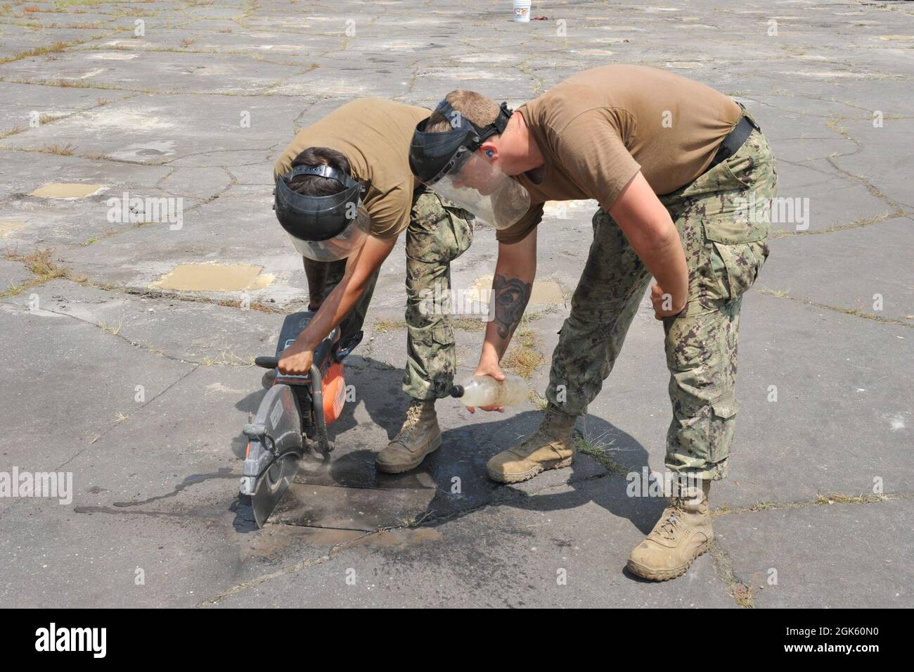 Seabees from Naval Mobile Construction Battalion (NMCB) 133 cut out a ...