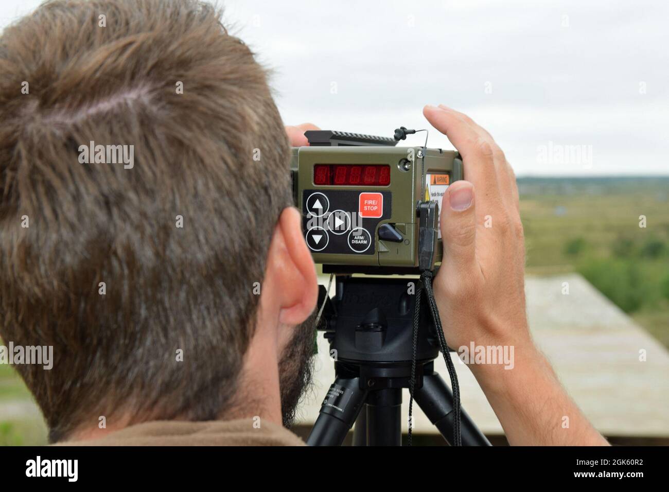 A Latvian Special Operation Forces member places a laser target using ...