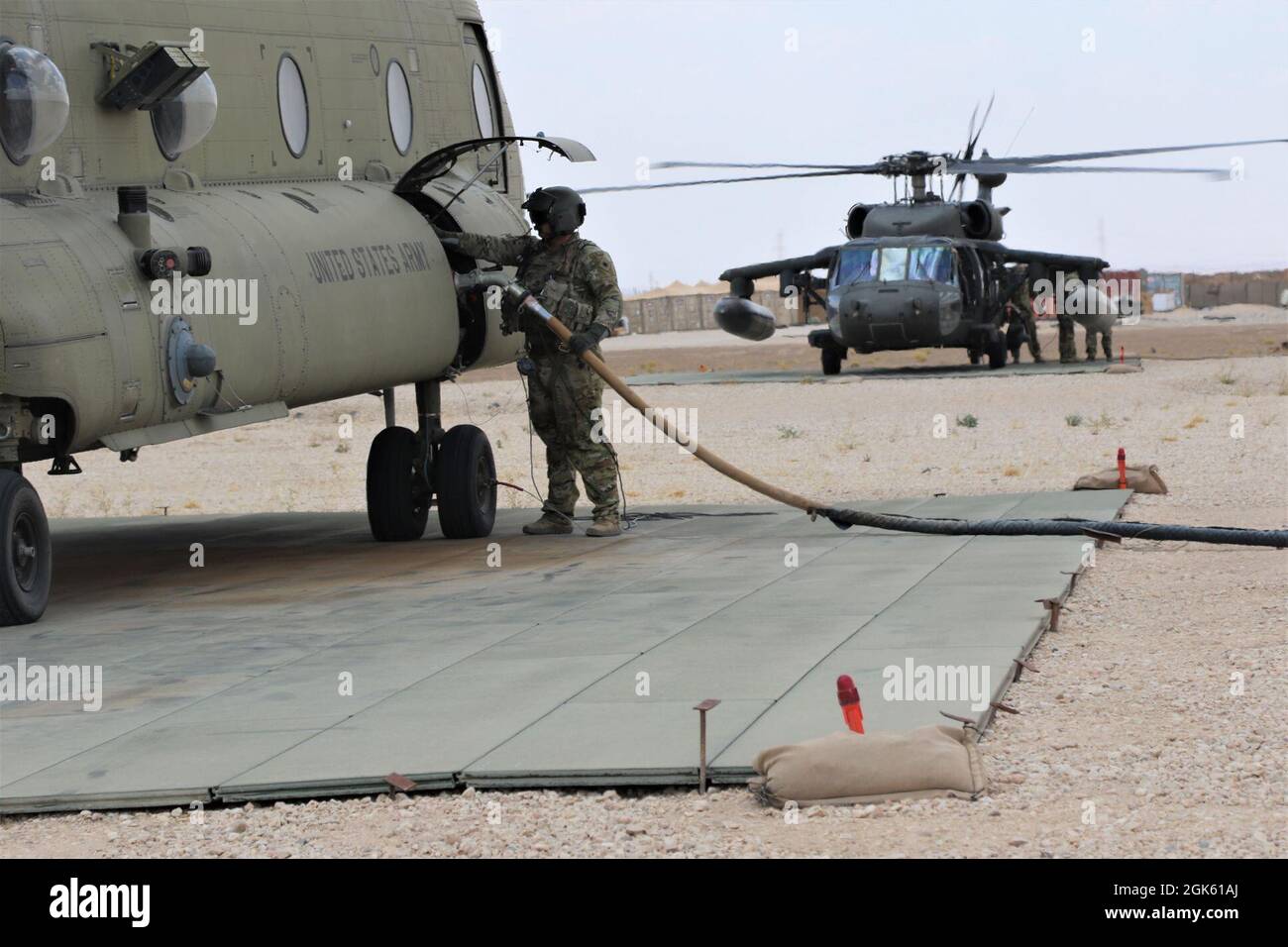 A Task Force Phoenix Soldier refuels a CH-47 Chinook helicopter from B ...