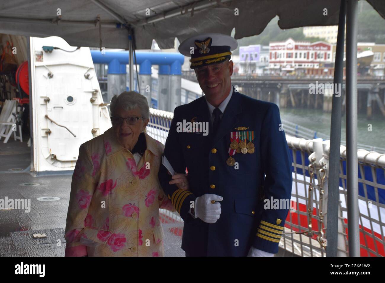 Capt. Alan McCabe escorts Jonna Midgette, the matron of honor, during ...