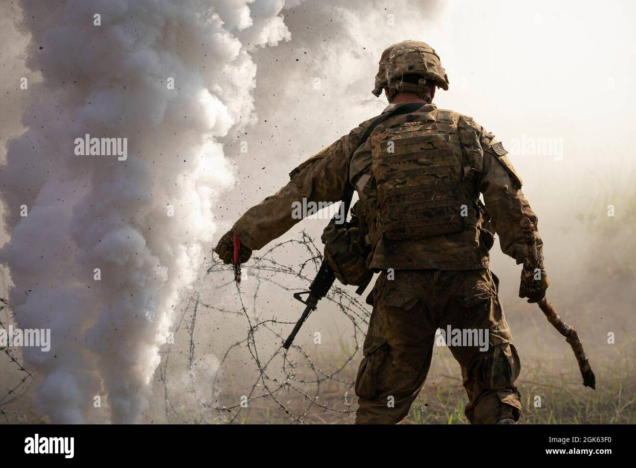A U.S. Army Soldier with Task Force Warrior moves concertina wire using ...