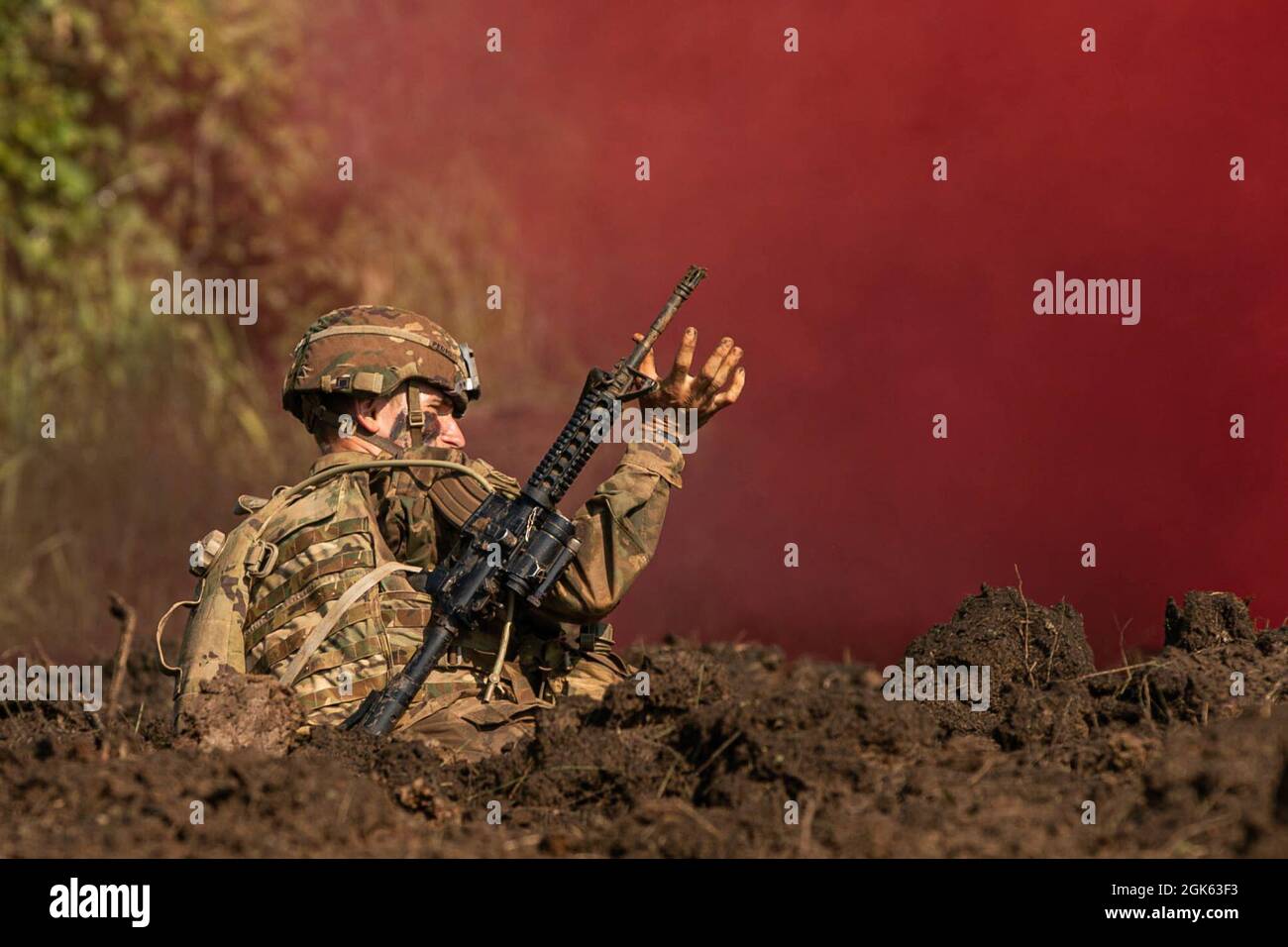 A U.S. Army Soldier with Task Force Warrior finds cover in the dirt and ...