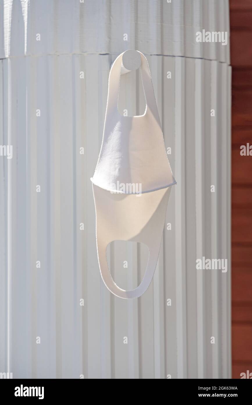 White Cloth Mask Hanging at Wall Peg Stock Photo - Alamy