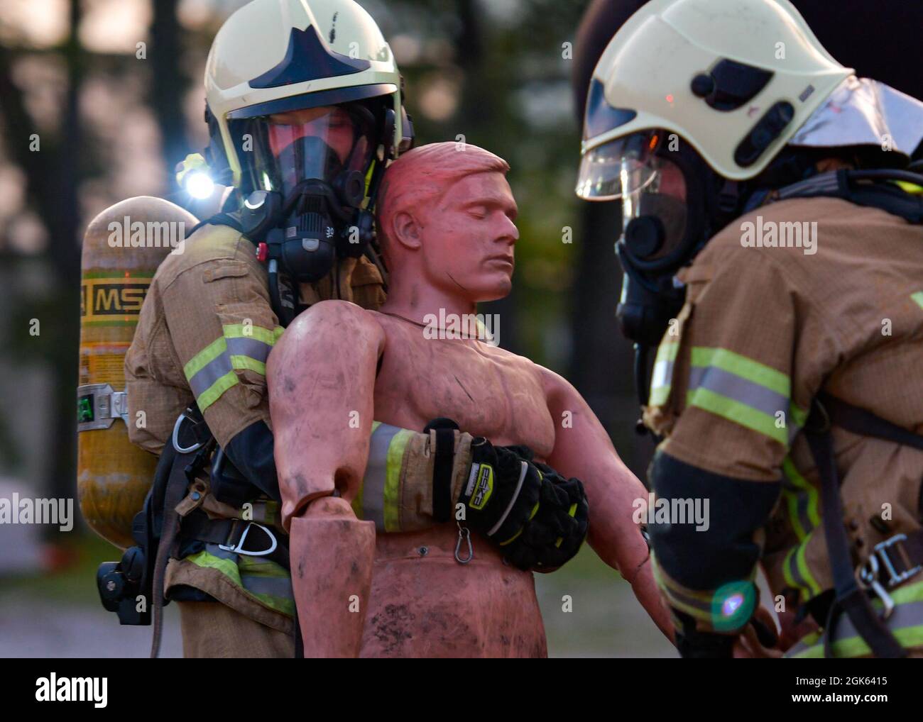 A Latvian National Armed Forces firefighter carries a dummy doll during ...