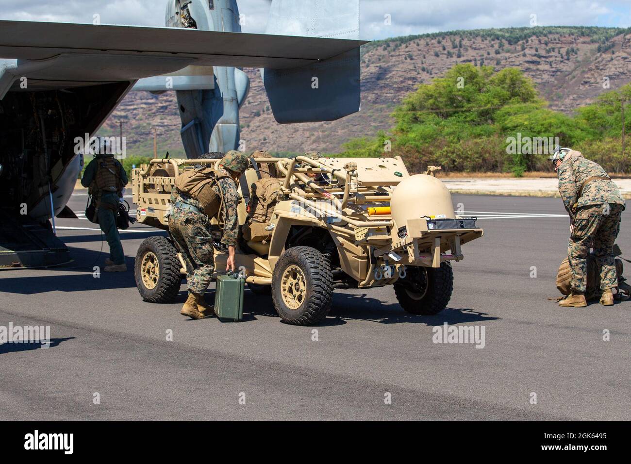U.S. Marines with 3d Marines, 3d Marine Division, offload a Network On ...