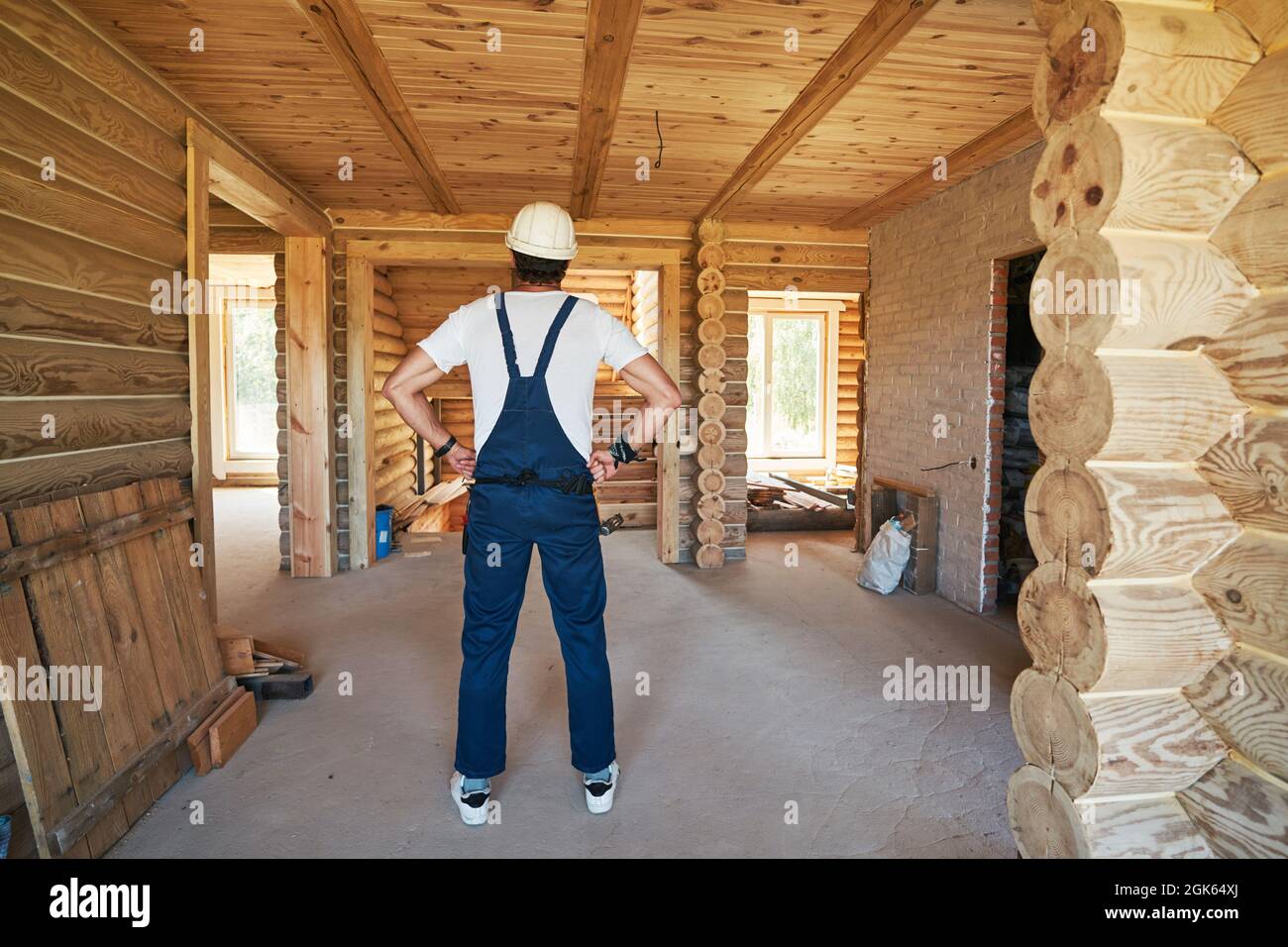 Builder is looking around house under construction Stock Photo - Alamy