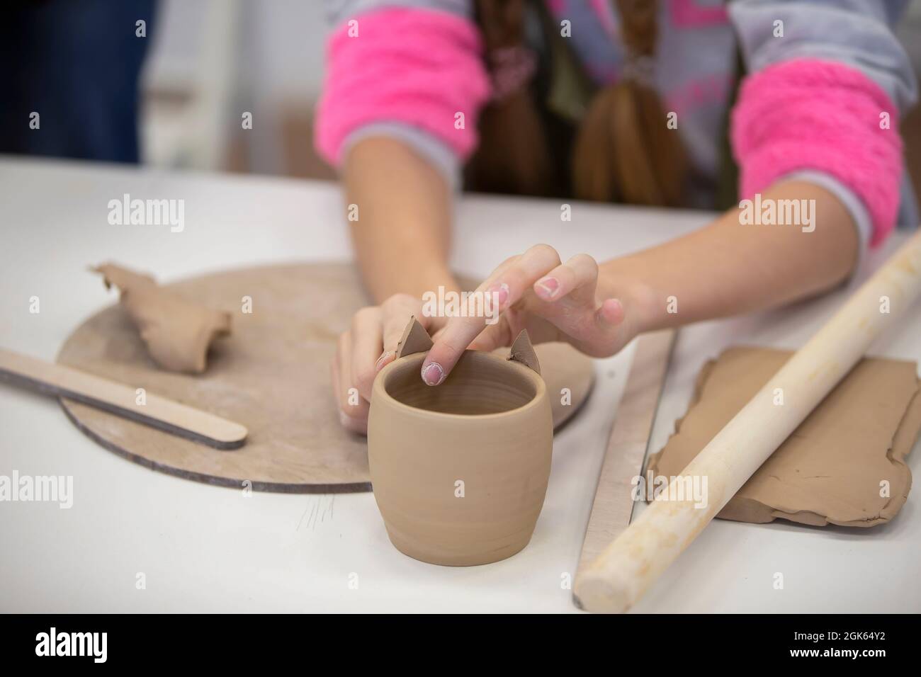 Clay modeling workshop. Hands make an earthenware cup Stock Photo - Alamy