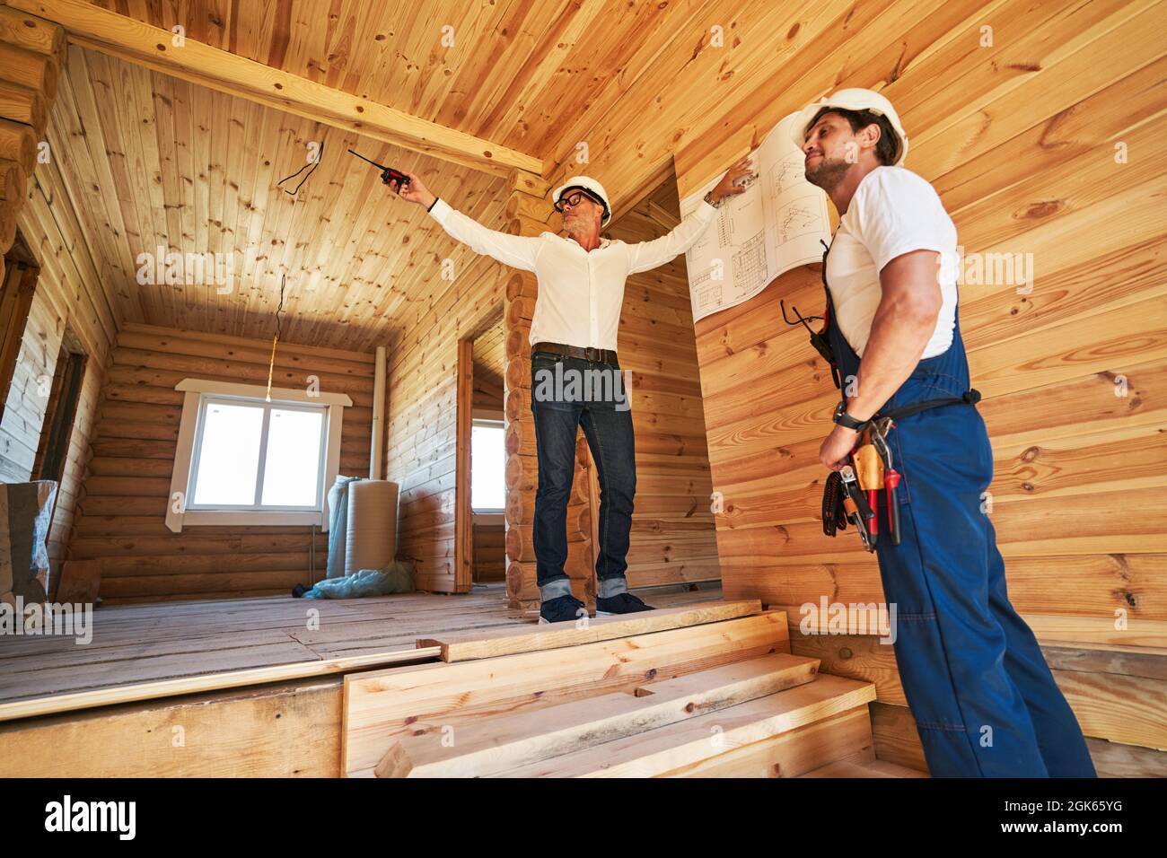 Engineer giving order to builder to work in specific area Stock Photo ...