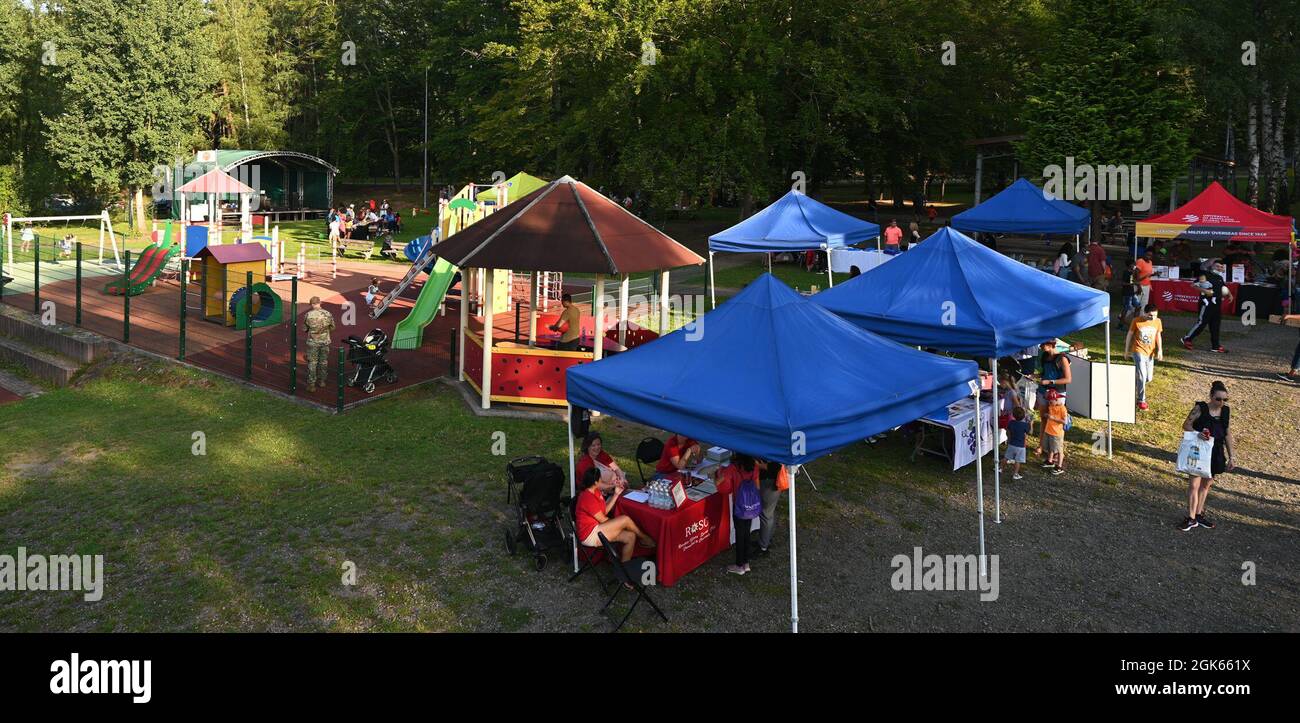 People walk around Community Cares Partners Party in the Park event on ...