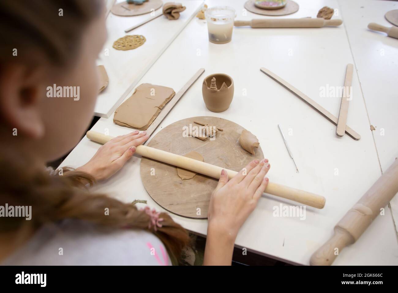 Master class in clay modeling. A teenage girl sculpts from clay Stock ...