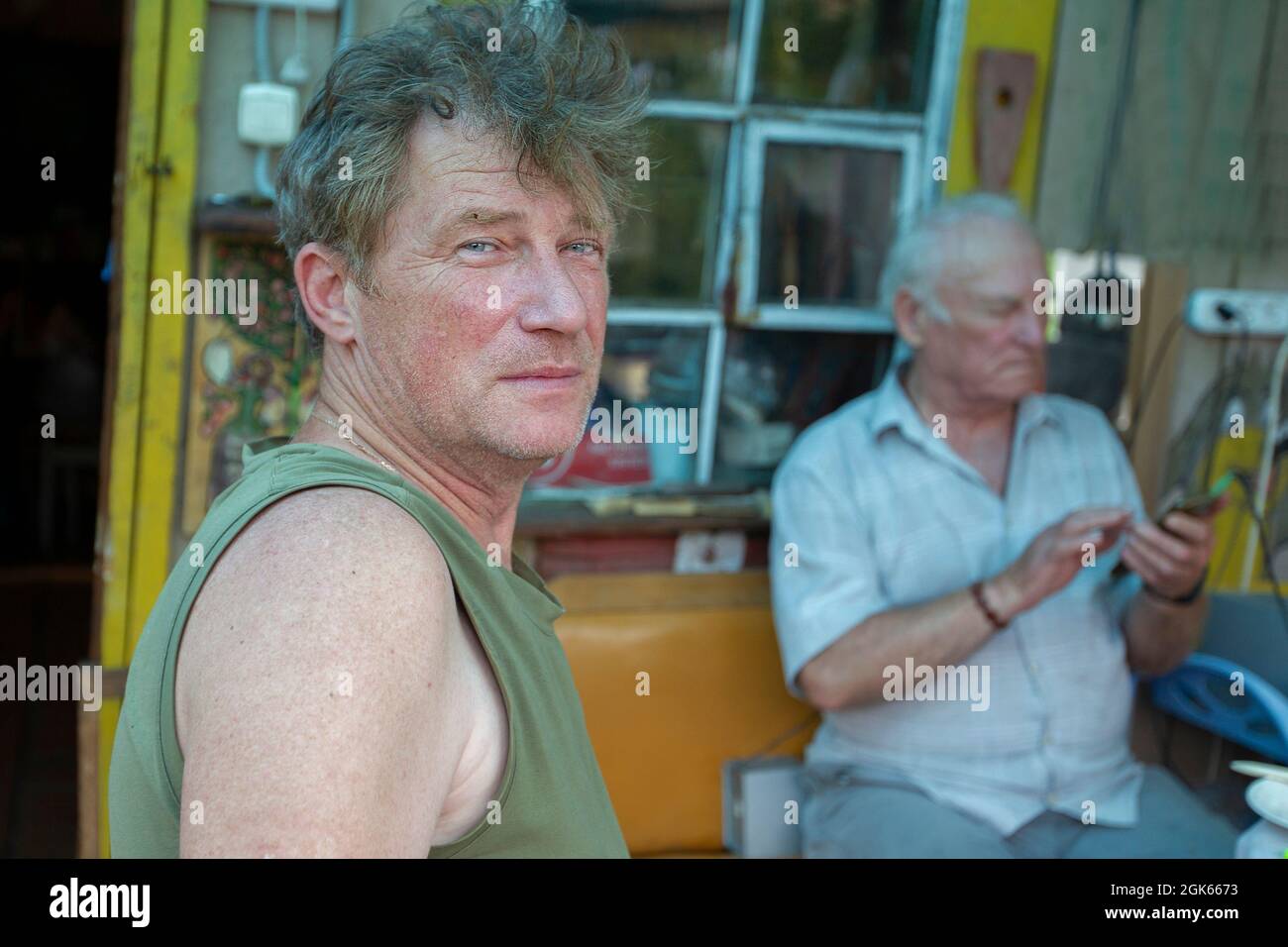 An adult son on the background of an elderly old man's father. Father ...