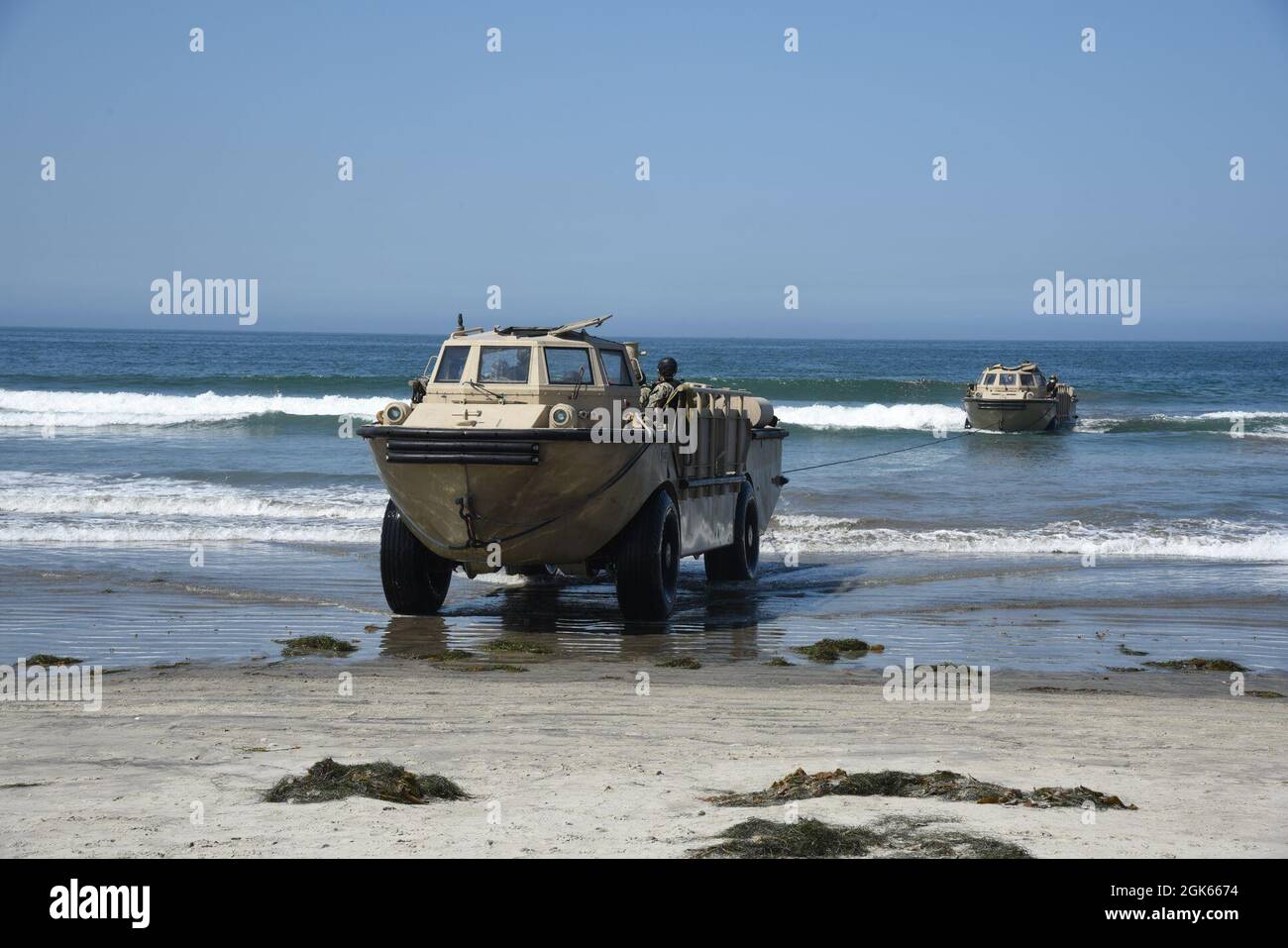 A Lighter Amphibious Resupply Cargo (LARC) vehicle tows a second LARC ...