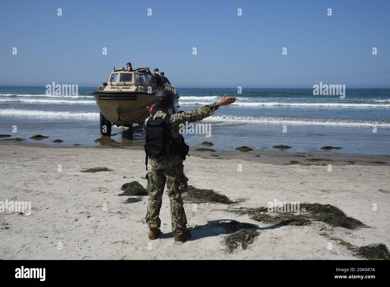 A Sailor assigned to Beachmaster Unit 1 directs a Lighter Amphibious ...