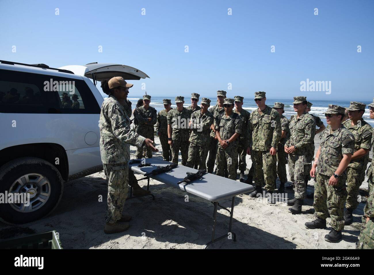 Fire Controlman (AEGIS) 1st Class Noelle Ervin, left, briefs U.S. Naval ...