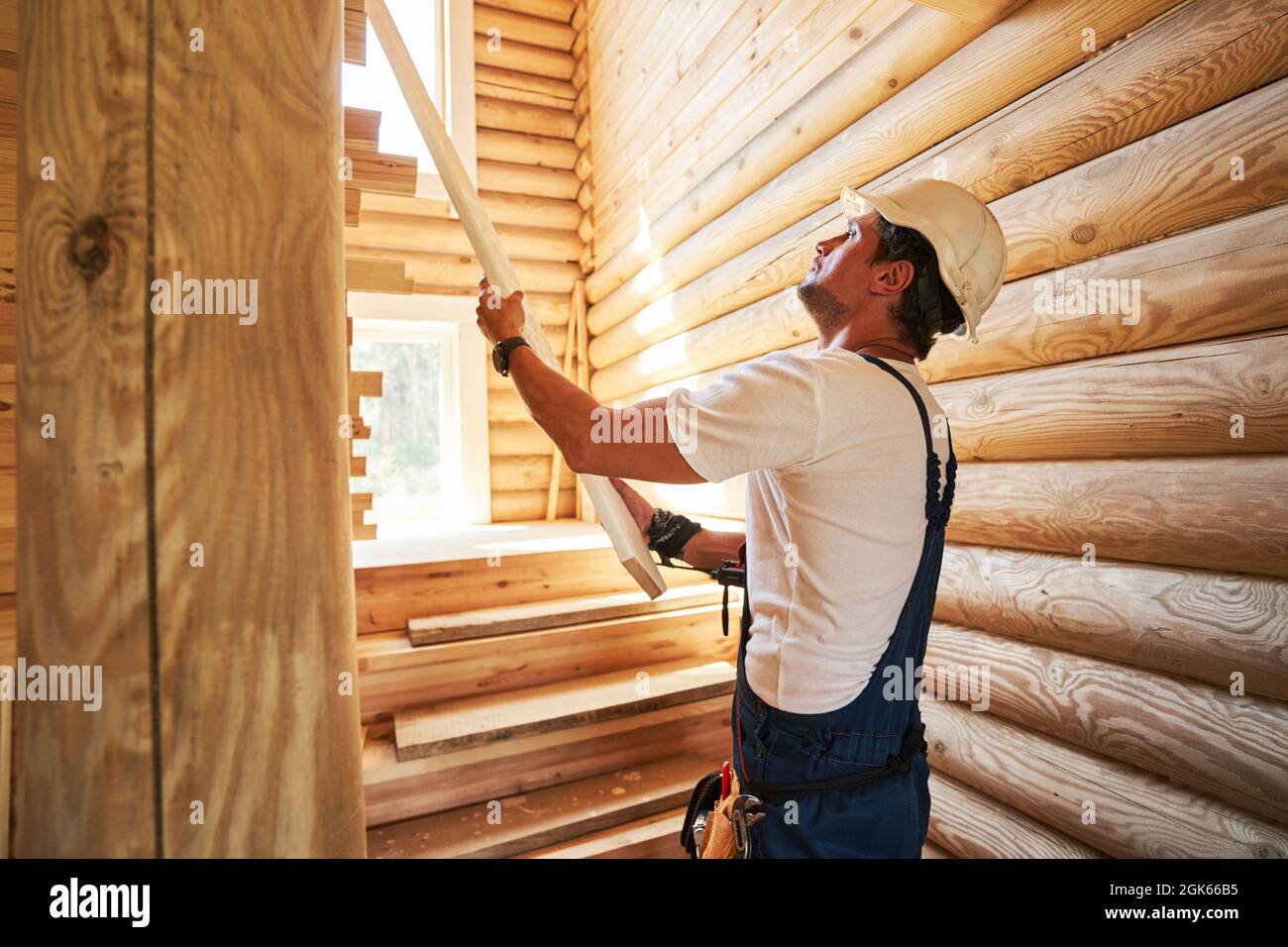 Worker putting wooden board hi-res stock photography and images - Alamy