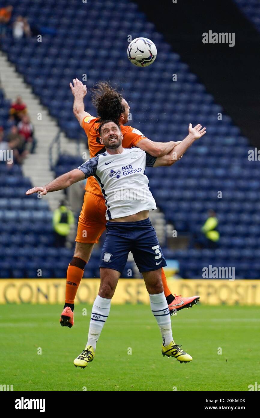 Hull’s Lewis Coyle competes for a header with Preston's Greg Cunningham ...