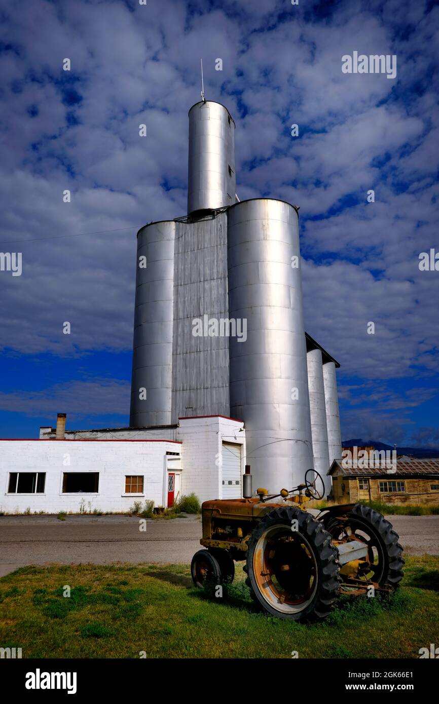 Old abandoned granary or tall grain silos in rural area with blue sky ...