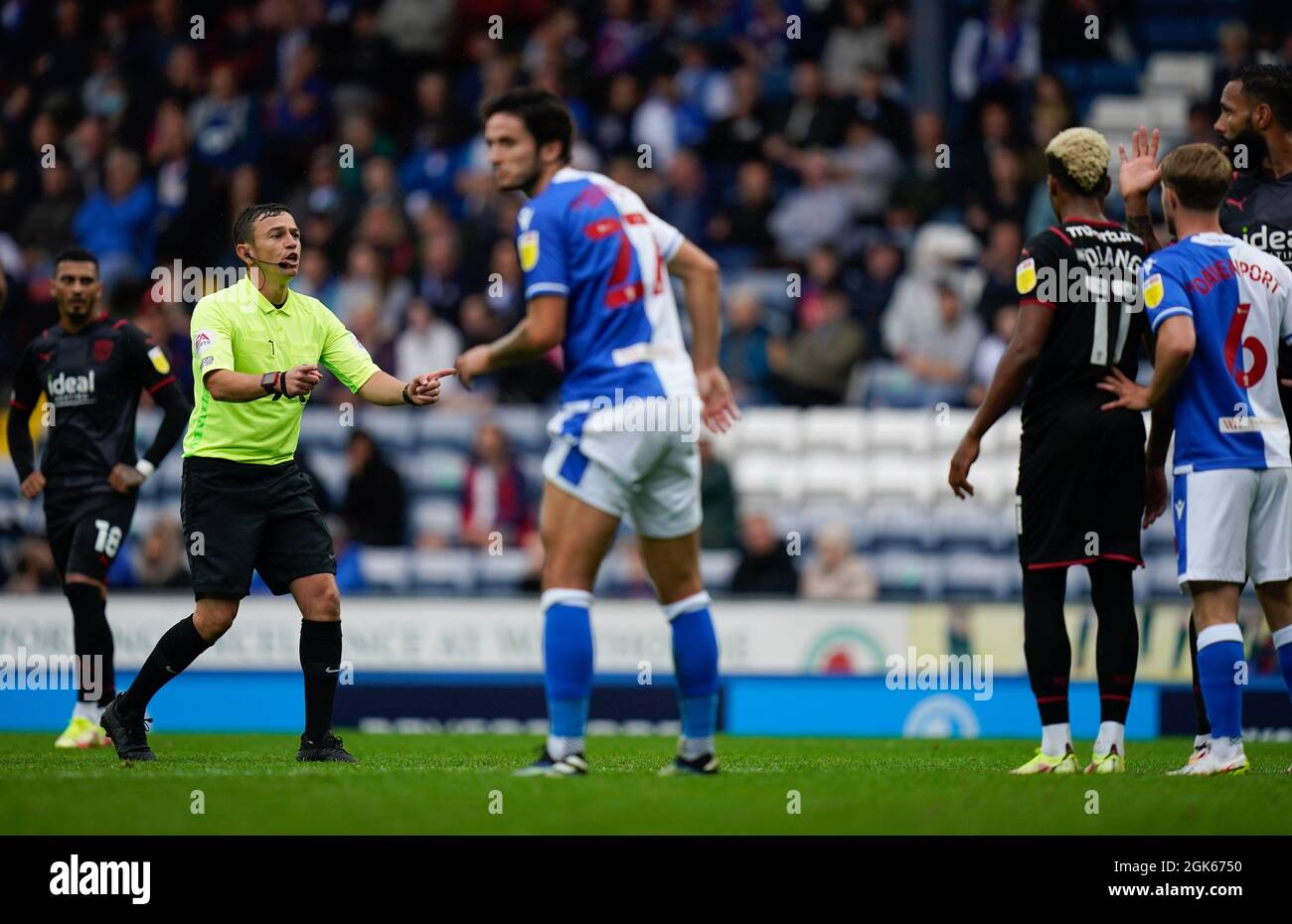 Referee Tony Harrington tries to control the players in a wall Picture ...