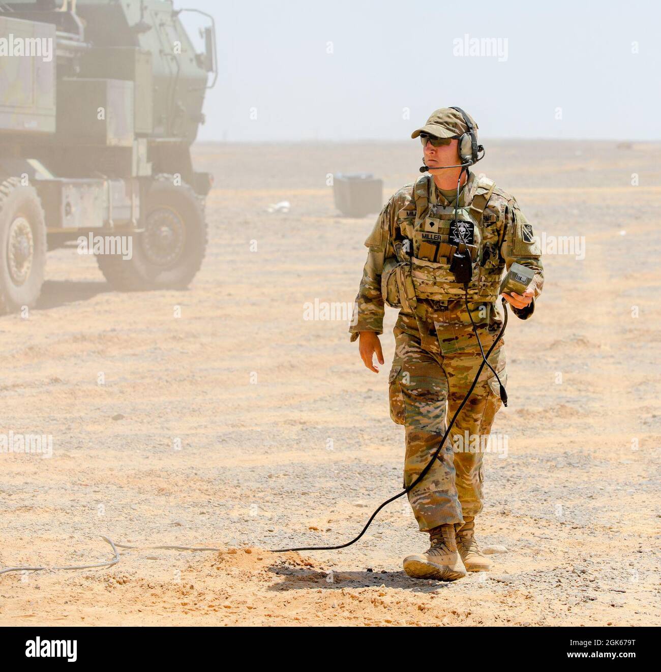 U.S. Army Spc. William Miller, assigned to Task Force Iron Valor, helps ...