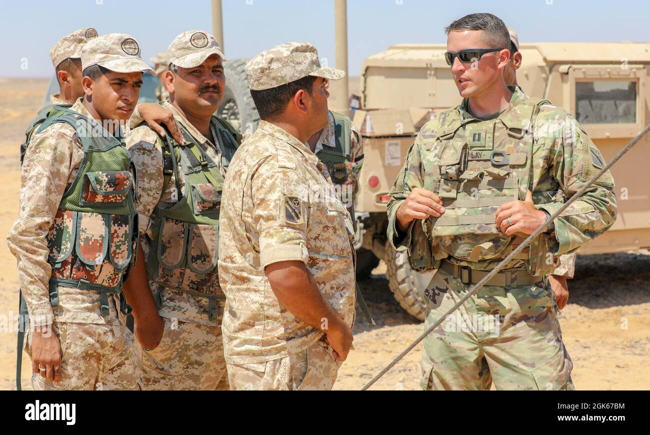 Capt. Matt Lay, assigned to Task Force Iron Valor, speaks with soldiers ...