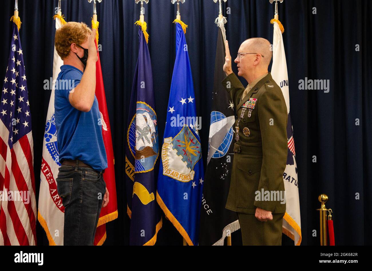 Marine Corps Col. Rich Brady conducts the oath of enlistment to Britt ...