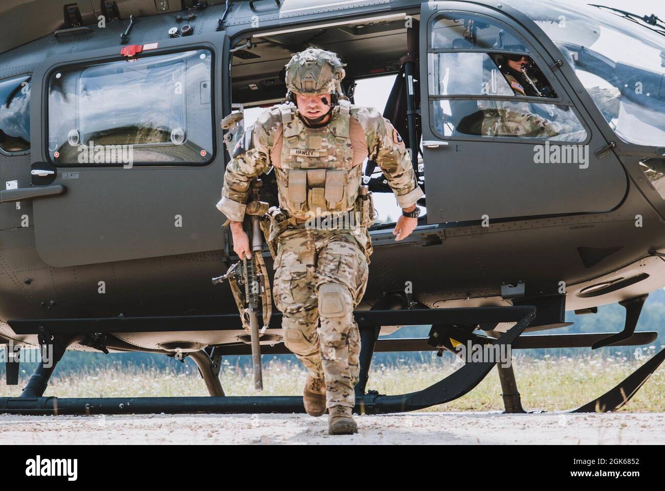 A sniper team exits a helicopter after shooting targets from the air ...