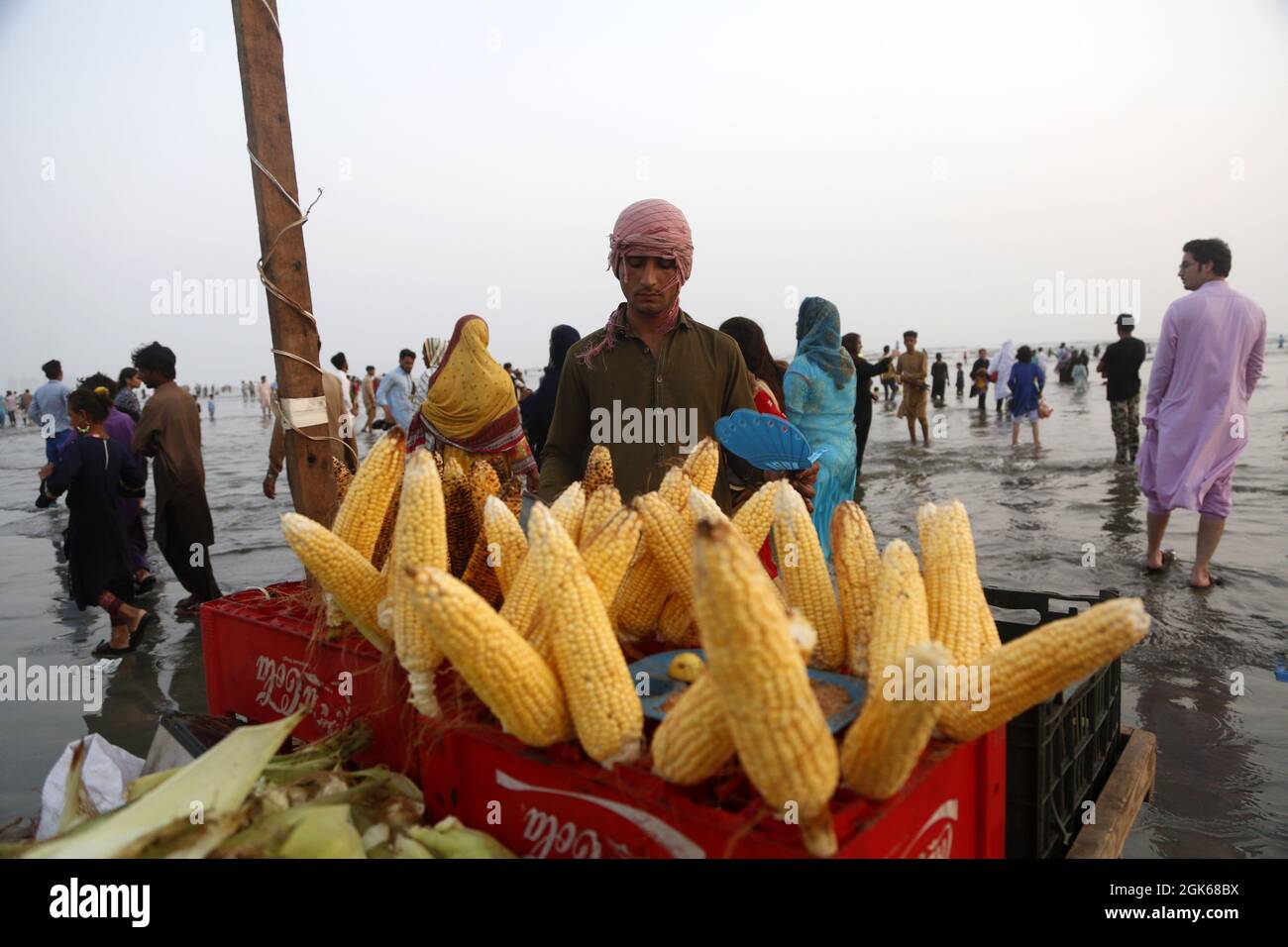 Karachi. 13th Sep, 2021. A vendor sells corn at a beach in southern ...
