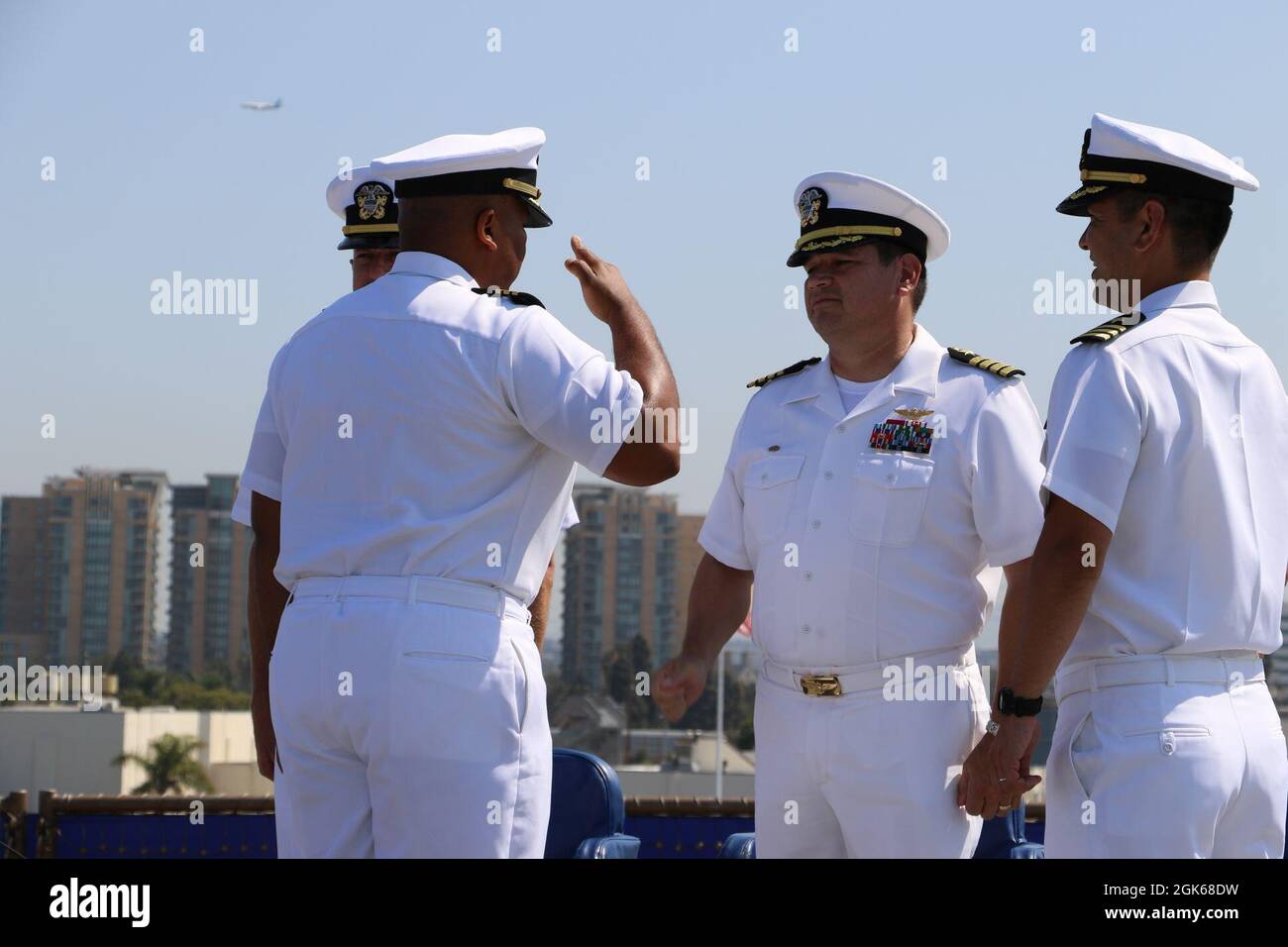 NAVAL BASE SAN DIEGO (Aug. 13, 2021) – Cmdr. Eric Winn, left, salutes ...