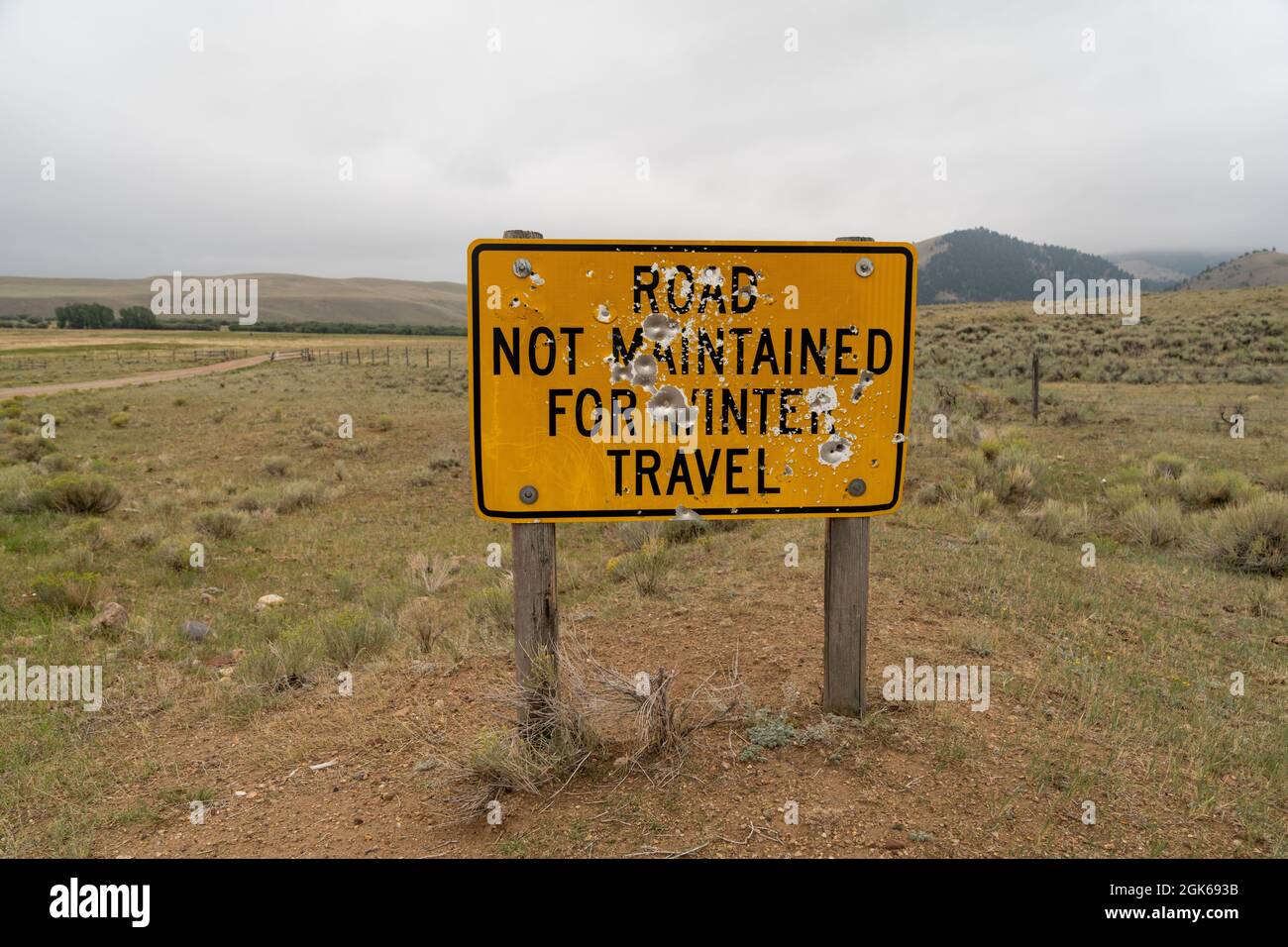 Road not maintained for winter travel sign, with bullet holes Stock ...