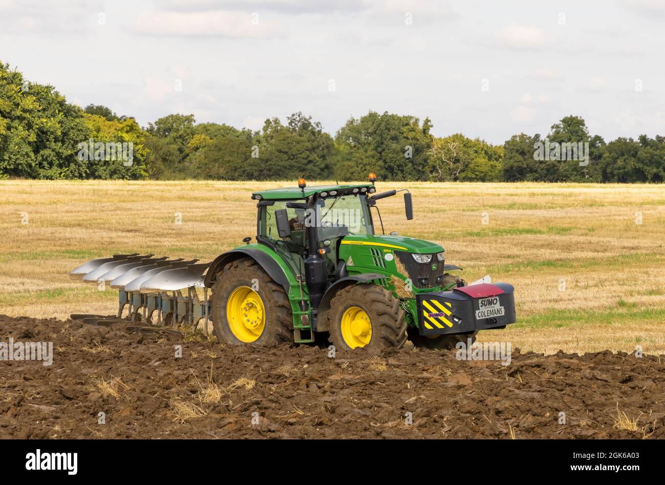 Farmer in a tractor ploughing a field in late summer Stock Photo - Alamy