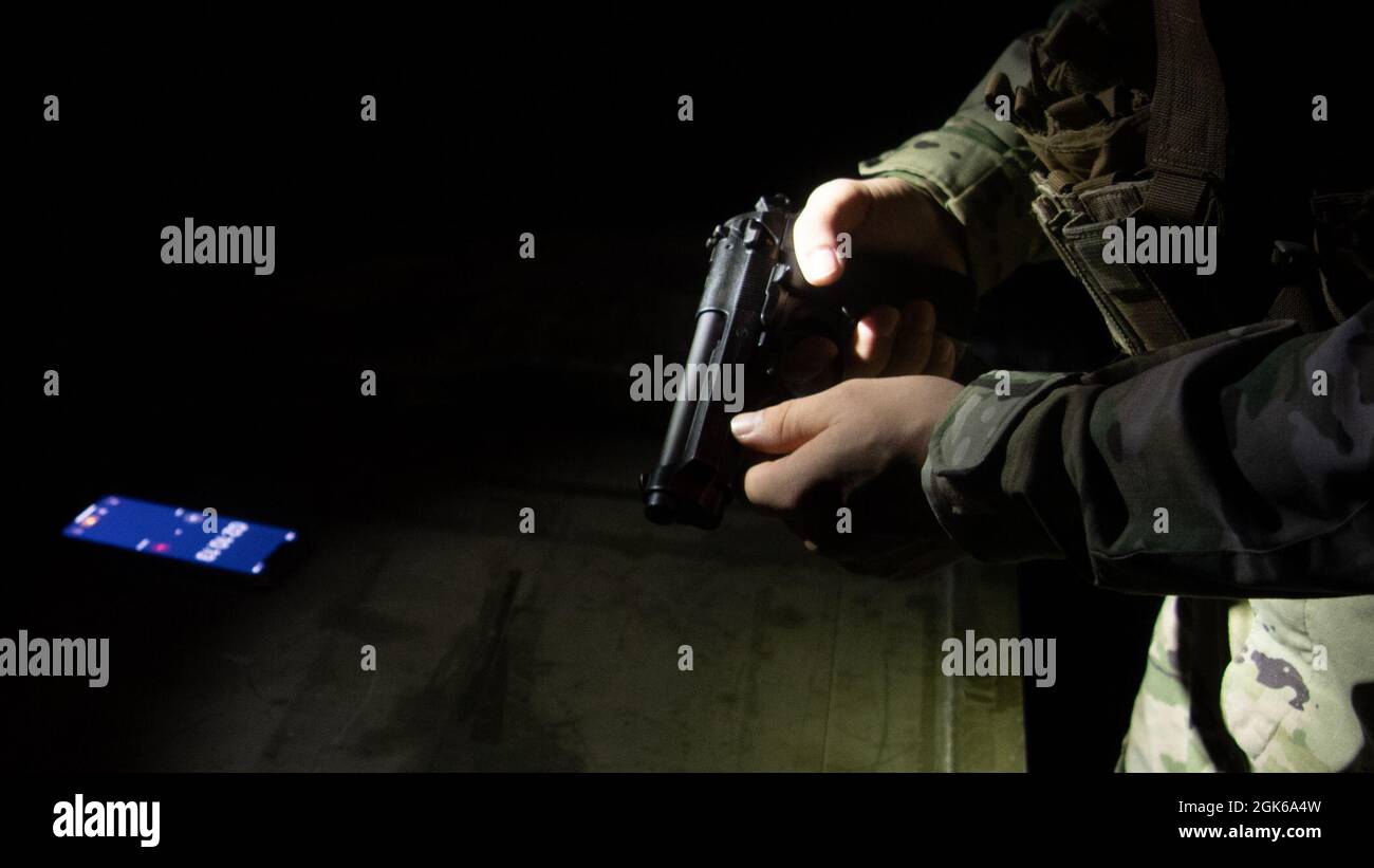 An 18th Security Forces Squadron defender disassembles an M-9 pistol ...