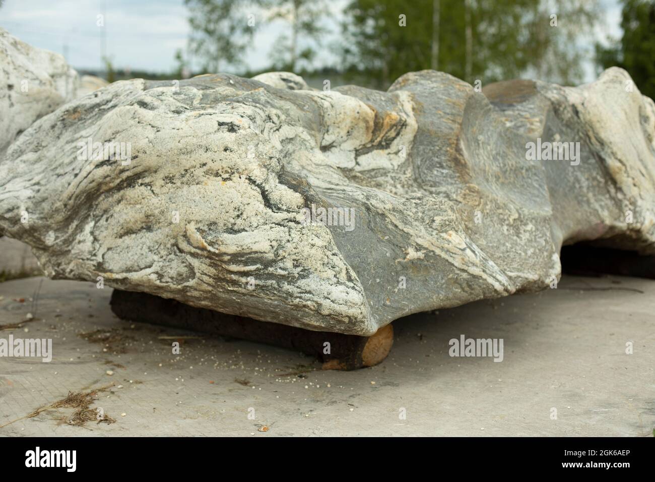 A large stone is installed in the park. Preparation of the rock for ...
