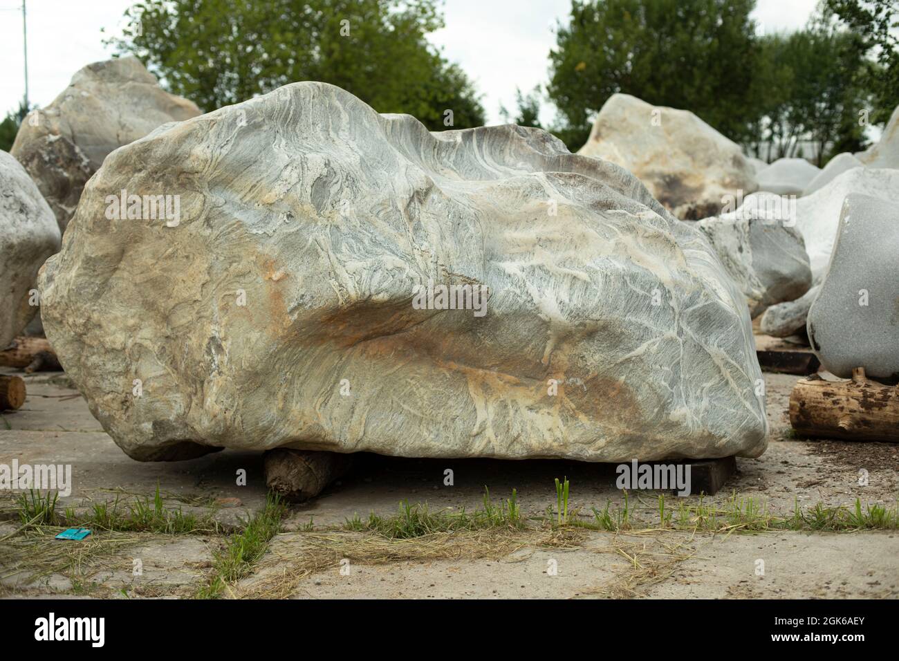 A large stone is installed in the park. Preparation of the rock for ...