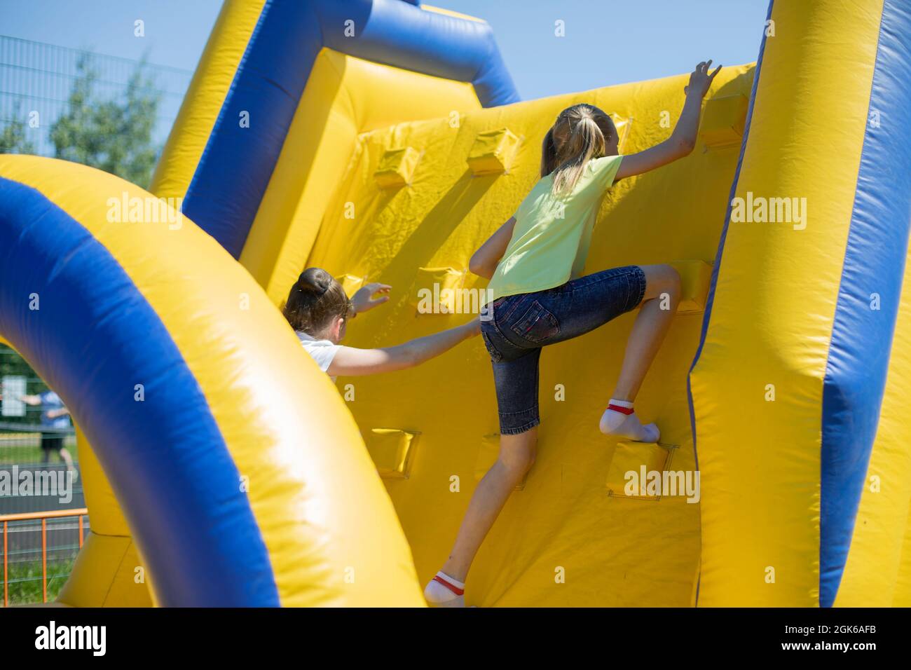 Children climb an inflatable slide. Inflatable obstacle course for fun ...