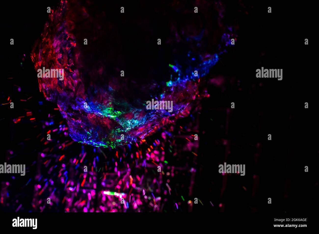 Colored water texture. Splashes of water lit in different colors. Close ...