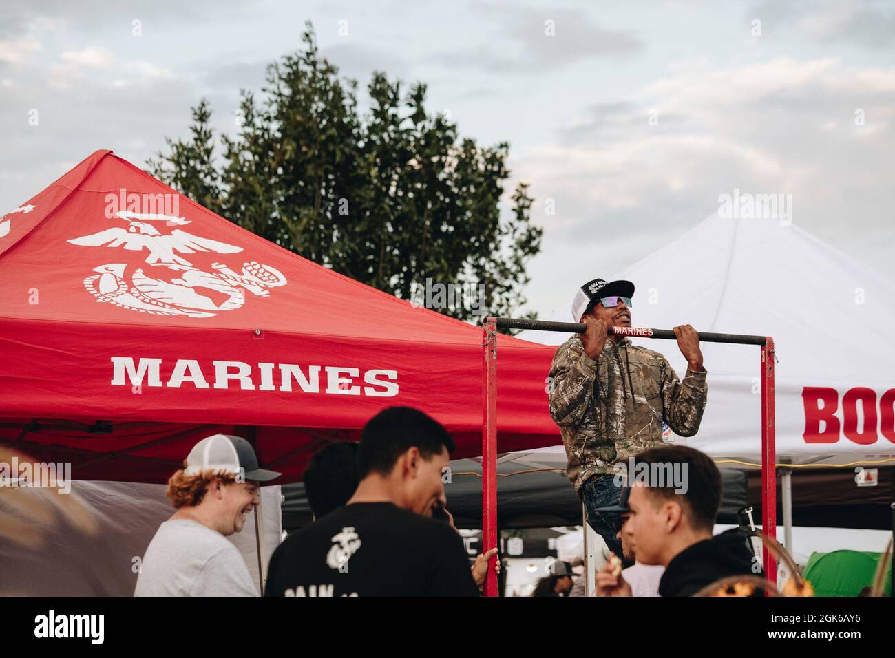 A rodeo attendee attempts pull-ups during a Marine Corps pull-up ...