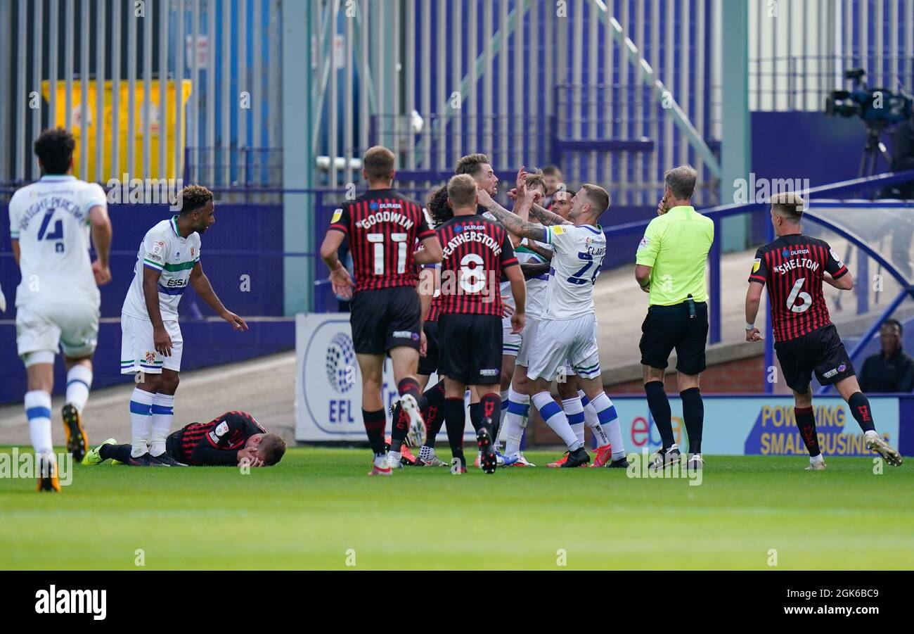 Referee Christopher Sarginson watches as Rovers Peter Clarke and ...