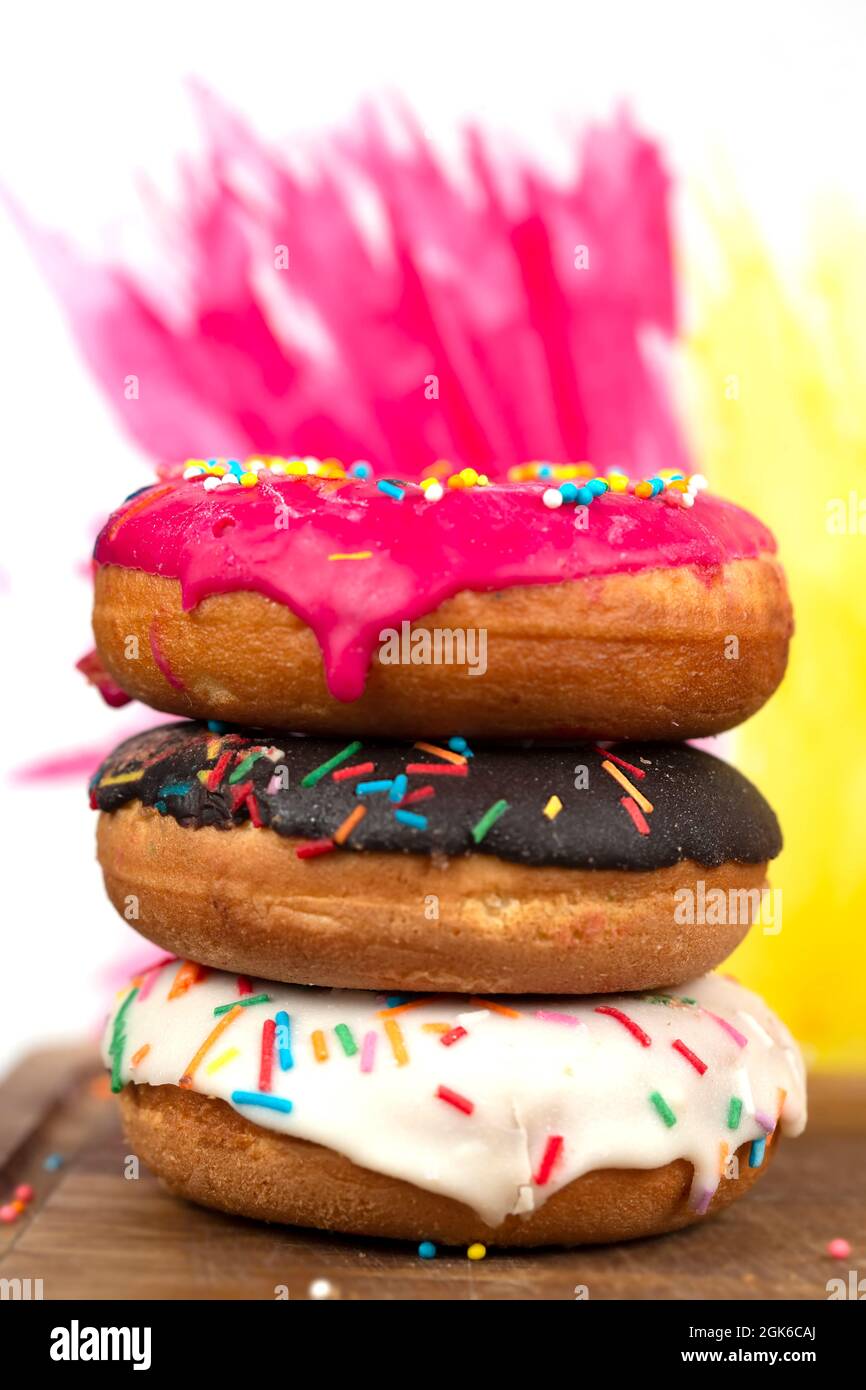 Creative sweet food. A stack of glazed colorful assorted donuts on a ...