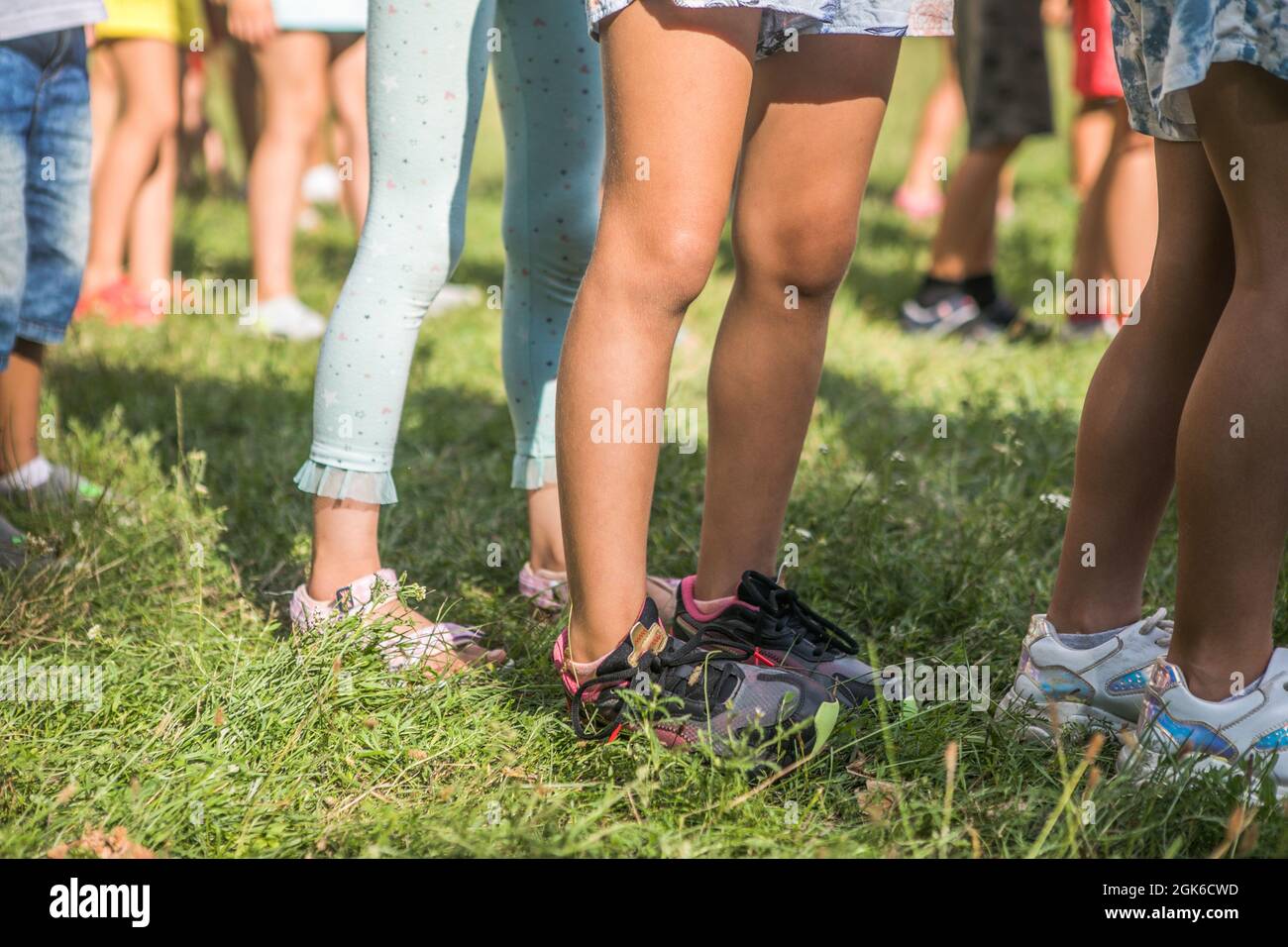 Children in a team game. kids together in motion outside and legs of ...