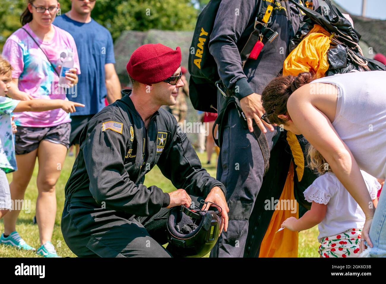 U.S. Army Spc. Mark Pierce, U.S. Army Parachute Team, interacts with ...