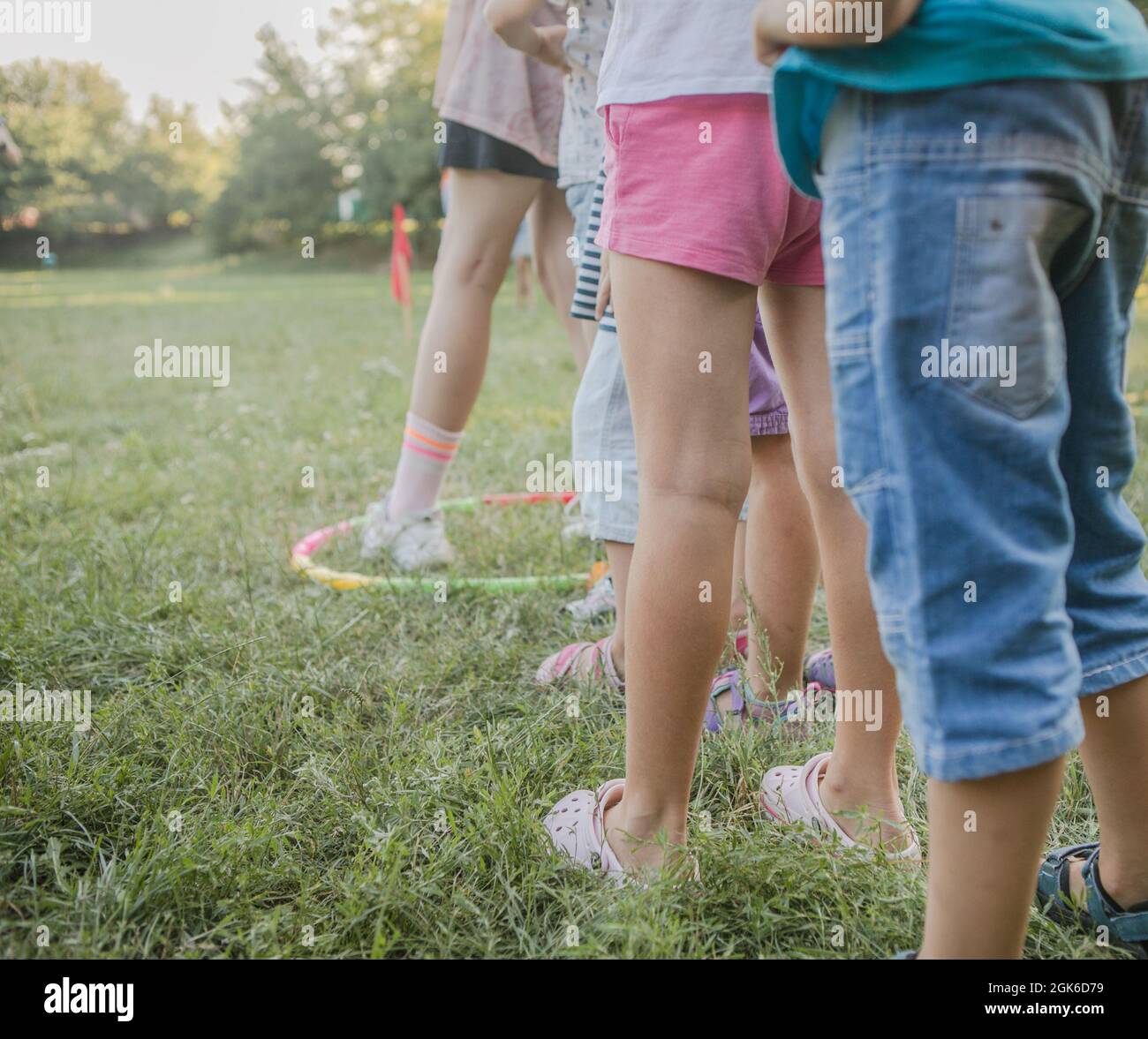 Children in a team game. kids together in motion outside and legs of ...