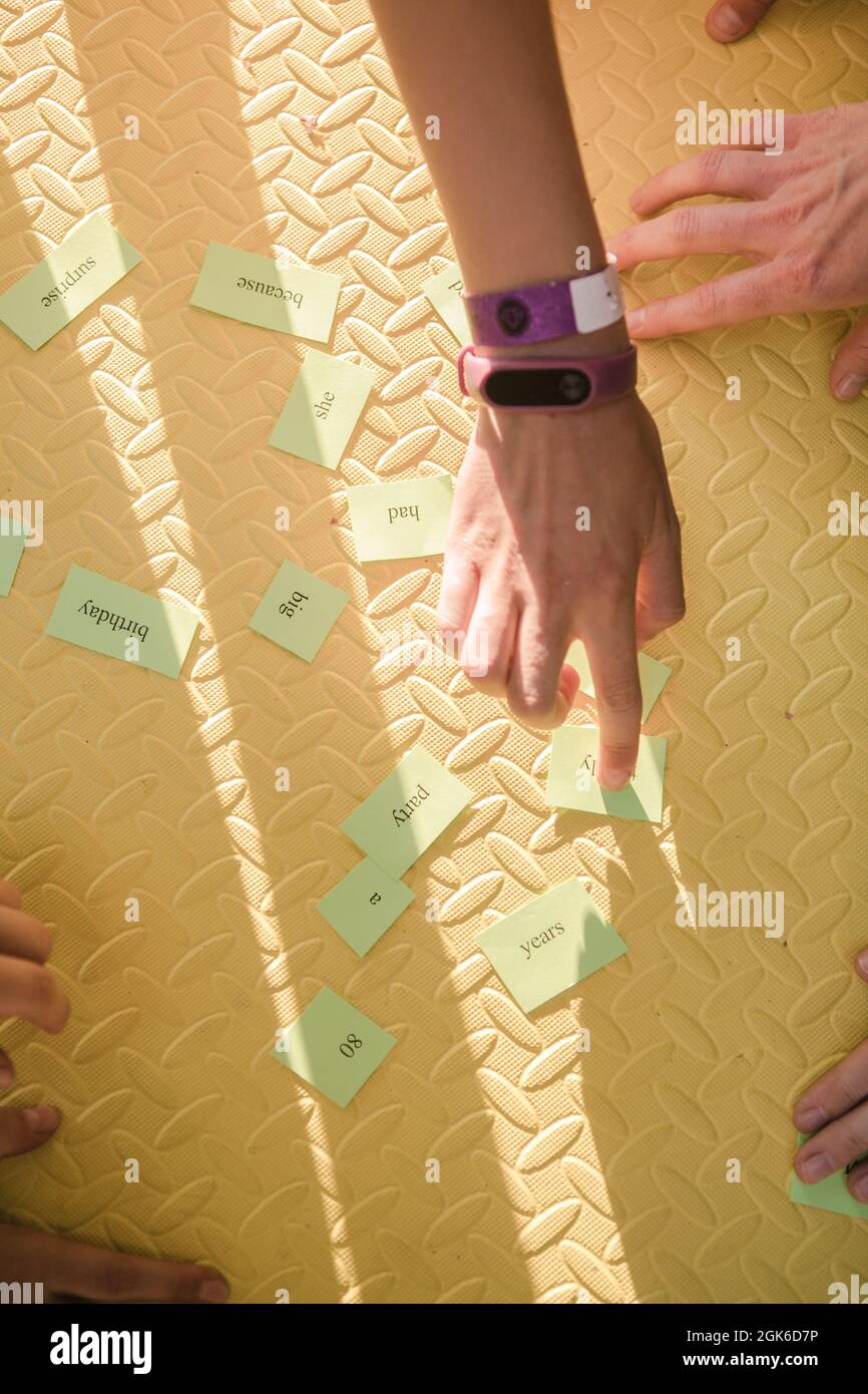 English lesson. Children assemble English words into sentences Stock ...