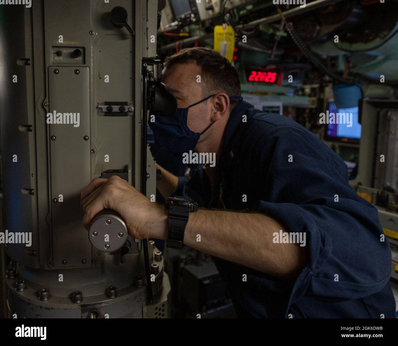 PACIFIC OCEAN (Aug. 14, 2021) Lt. j.g. Raymond Gerrety looks through a ...