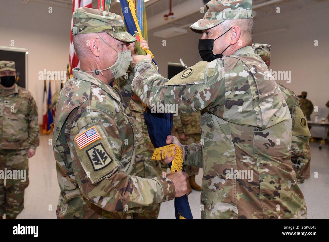 Incoming Command Sgt. Maj. Steven J. Slee, left, receives the colors ...