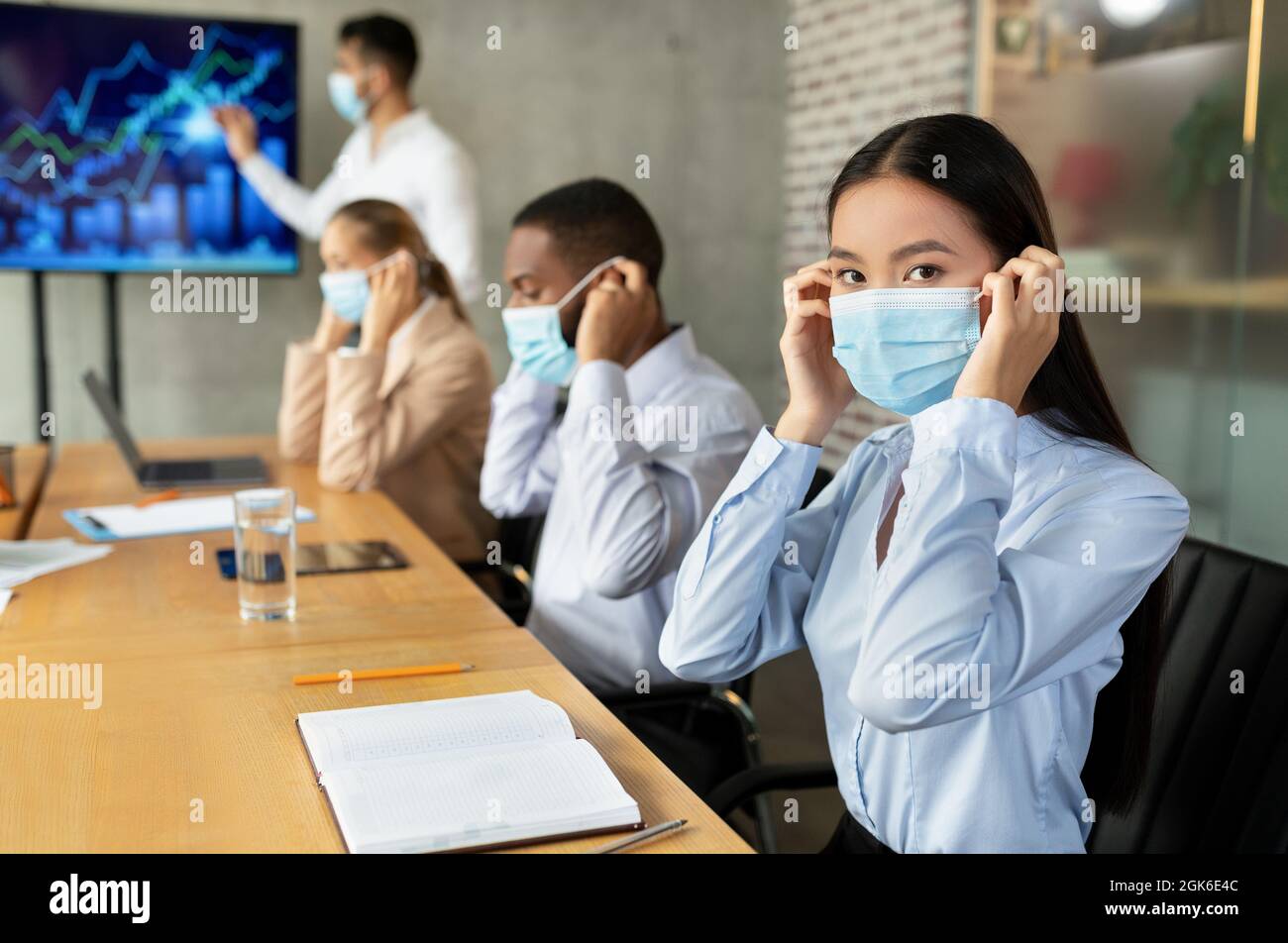 Multiethnic Business People Putting Medical Masks At Corporate Meeting ...
