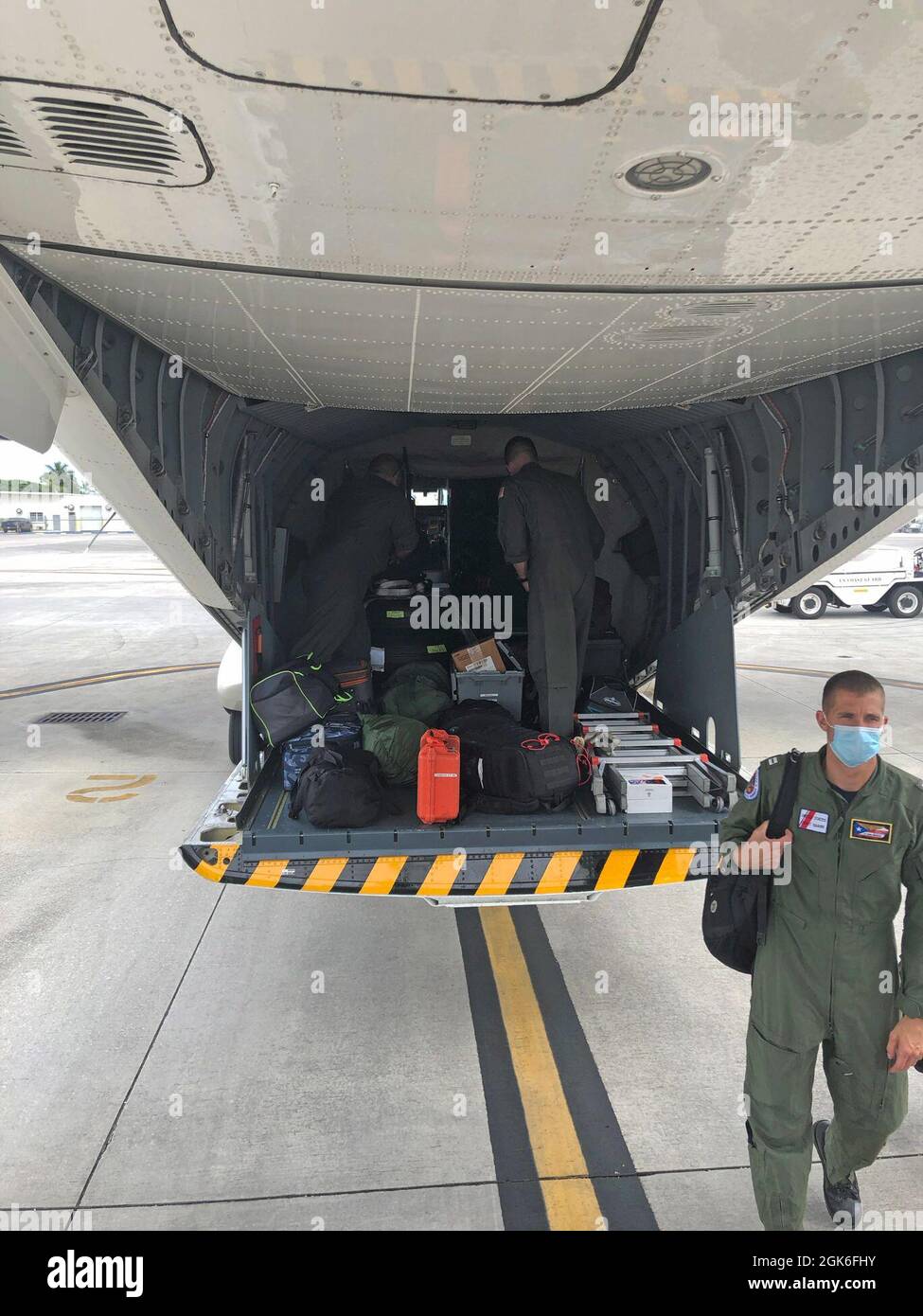 U.S. Coast Guard HC-144 Ocean Sentry crews from Air Station Miami load ...