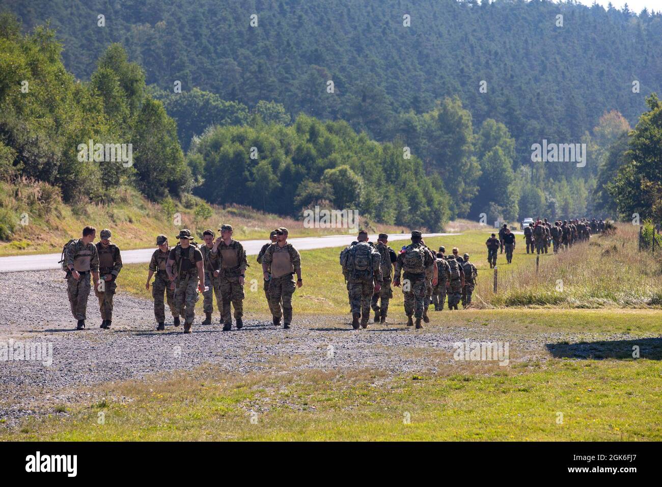 Competitors within the first Dancon March ruck along the trail Aug. 15 ...