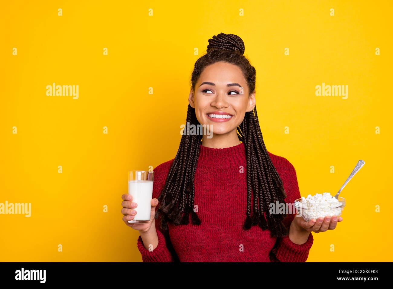 Photo of dreamy cute dark skin woman dressed red sweater holding cream ...