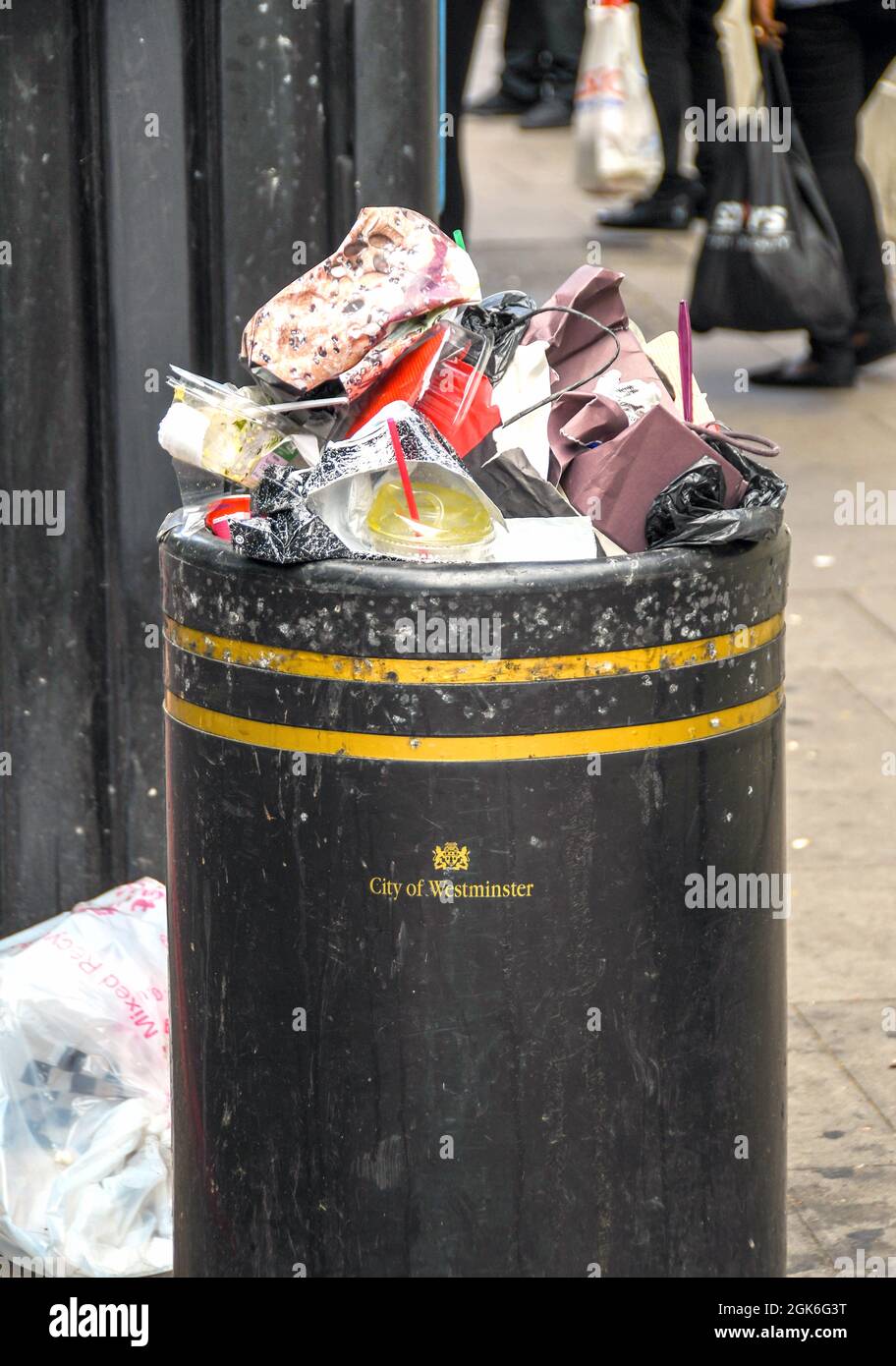 London, England - June 2018: Rubbish bin overflowing on a city street ...